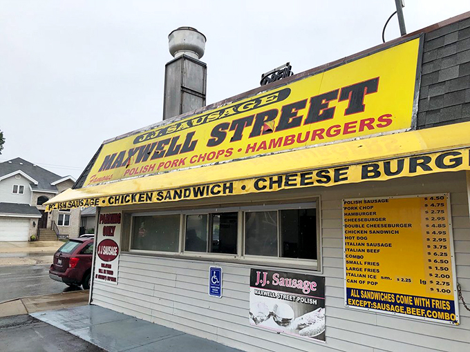 Welcome to flavor town! J.J. Sausage's yellow awning beckons like a culinary lighthouse, guiding hungry souls to pork chop paradise.