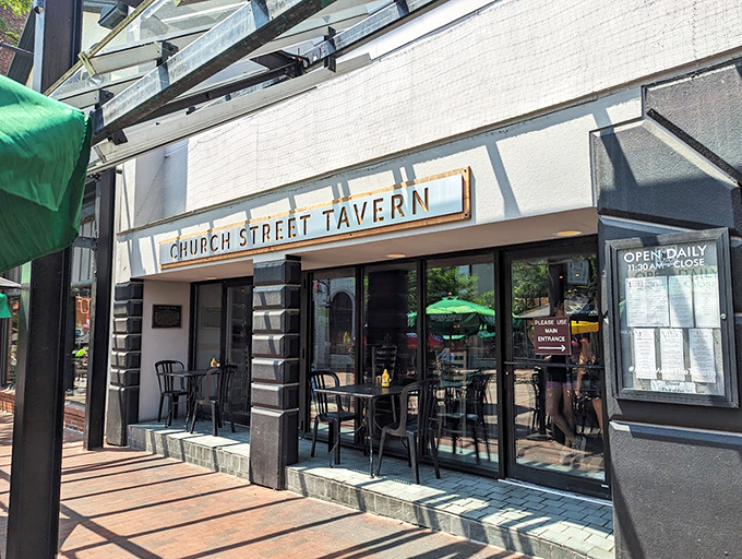 A welcoming beacon on Burlington's Church Street, where the classic tavern sign promises comfort and hospitality beneath Vermont's summer sky.