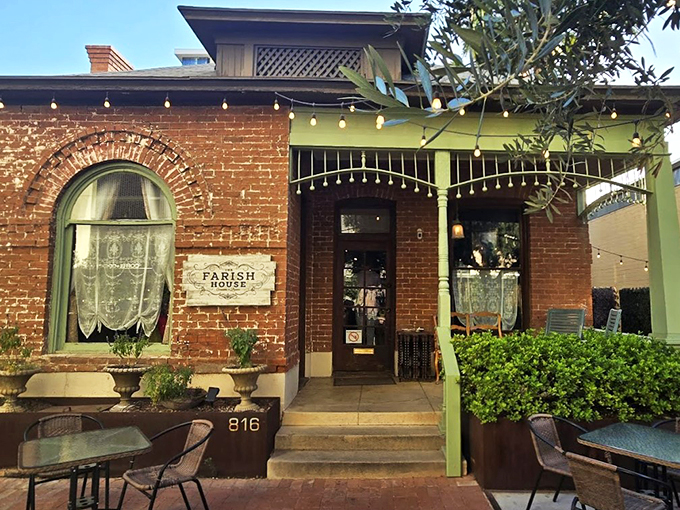 Step into a time machine disguised as a charming brick house. The Farish House beckons with its string lights and inviting porch, promising a culinary adventure that's anything but ordinary.