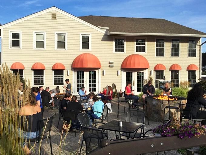 A welcoming coastal haven with coral-colored awnings, where the aroma of smoked meats mingles with salty ocean breezes.