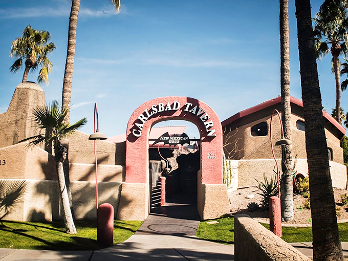 Like a pink adobe mirage in the desert, Carlsbad Tavern's entrance beckons with Southwestern charm and towering palm trees.