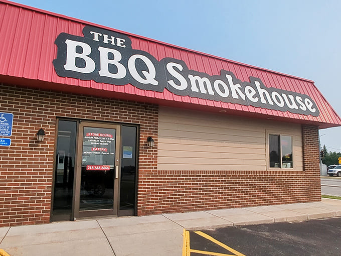 That red awning beckons like a lighthouse for hungry travelers, promising smoky salvation just beyond those doors.