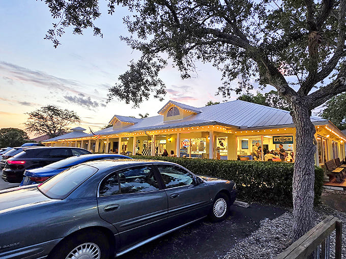 The cheerful yellow exterior of Royal Scoop glows at dusk, beckoning ice cream lovers like a sweet lighthouse on Bonita Beach Road.
