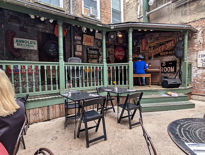Arnold's vintage green-trimmed exterior stands proudly on Cincinnati's 8th Street, a time capsule of hospitality with stories etched into every brick.