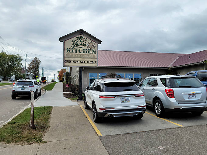 The welcoming facade of Mrs. Yoder's Kitchen stands proudly in Mt. Hope, where both cars and horse-drawn buggies find parking spots in this culinary crossroads.
