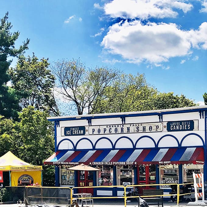 A blue and white time capsule with its iconic red-striped awning, standing proudly beside the waterfall since 1949.