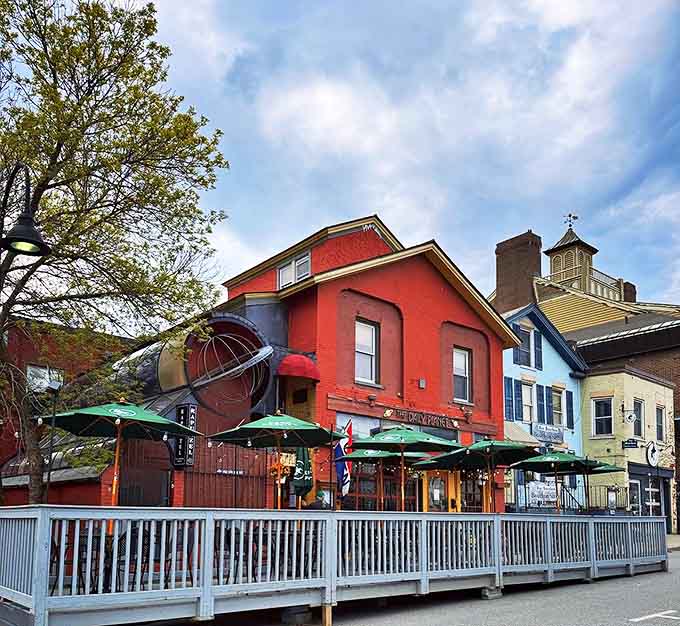 The distinctive red exterior of The Daily Planet beckons hungry travelers with its spacious deck and warm glow &ndash; Burlington's cosmic culinary beacon.