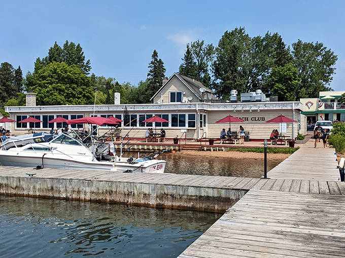 The Beach Club's waterfront location offers diners front-row seats to Lake Superior's splendor, with boats bobbing gently alongside the wooden dock.