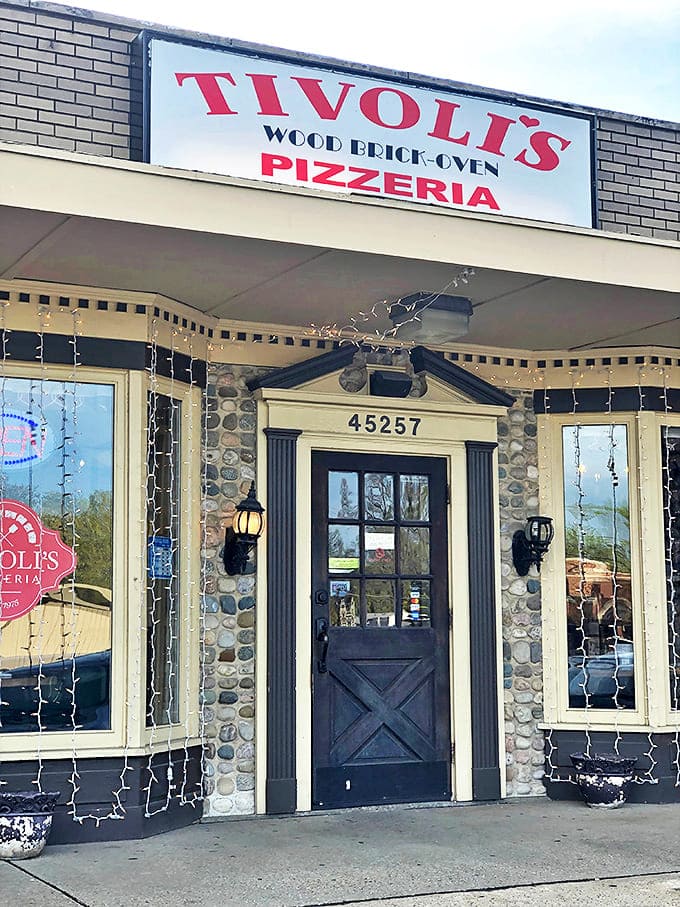 Exterior: Tivoli's charming stone facade welcomes pizza lovers with twinkling lights and the promise of wood-fired delights inside. No ordinary strip mall pizzeria here!