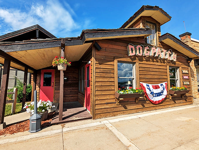 The rustic wooden exterior of Dogpatch Restaurant welcomes hungry travelers with its charming cabin-like facade and cheerful flower baskets—pure Upper Peninsula hospitality.
