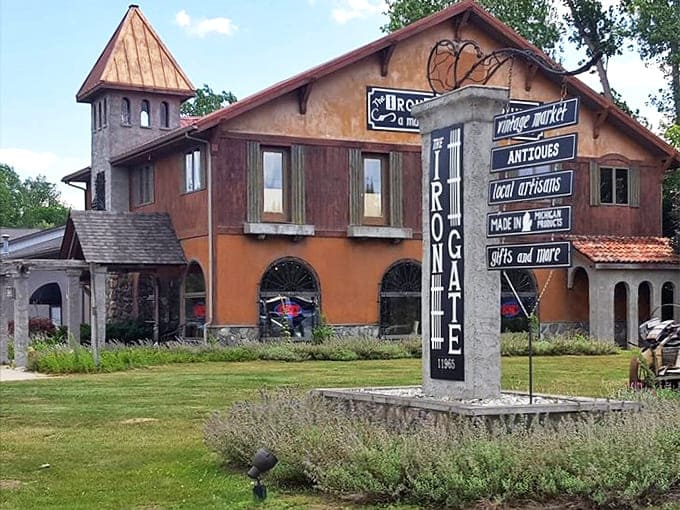 The Iron Gate Emporium stands like a Tuscan villa dropped into Michigan, its warm ochre walls and distinctive tower beckoning treasure hunters inside.