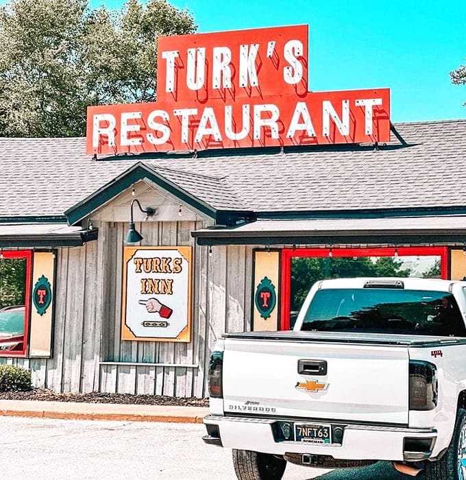 That bold red sign isn't just marking a restaurant, it's announcing a destination for serious sandwich lovers across the Midwest.