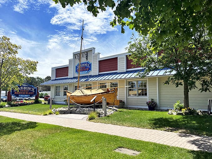 Darrow's exterior welcomes hungry travelers with its charming boat display and vibrant flower beds &ndash; a Great Lakes greeting that promises comfort inside.