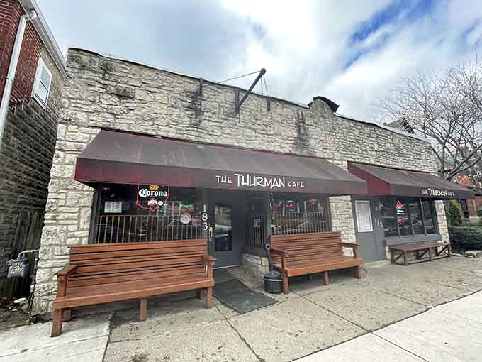 The unassuming stone exterior of Thurman Cafe, where wooden benches outside aren't just seating&mdash;they're waiting rooms for burger pilgrims seeking meaty salvation.