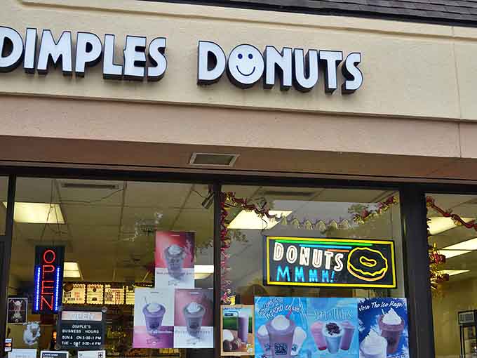 The cheerful Dimples Donuts storefront welcomes hungry visitors with its signature smiley face logo &ndash; a promise of good things to come.