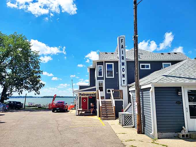 The blue-gray exterior of Fairmont Shores stands like a sentry guarding Cedar Lake's treasures, that vertical sign promising delicious secrets within.