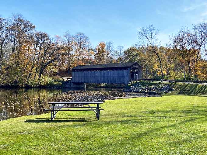 The historic wooden bridge stands as a sentinel over time, inviting visitors to cross into Fallasburg Park's storied past.