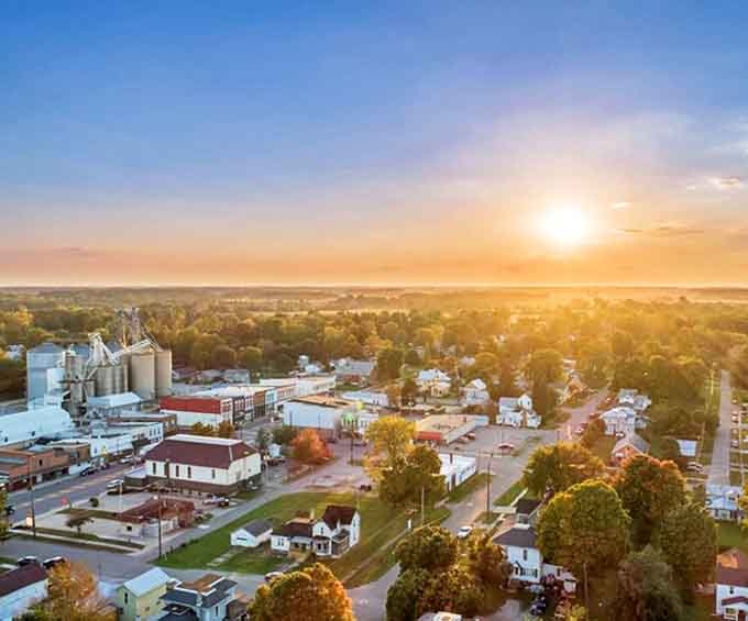 Fayette: Golden hour bathes this heartland haven in warm light, where grain elevators stand like sentinels guarding small-town treasures.