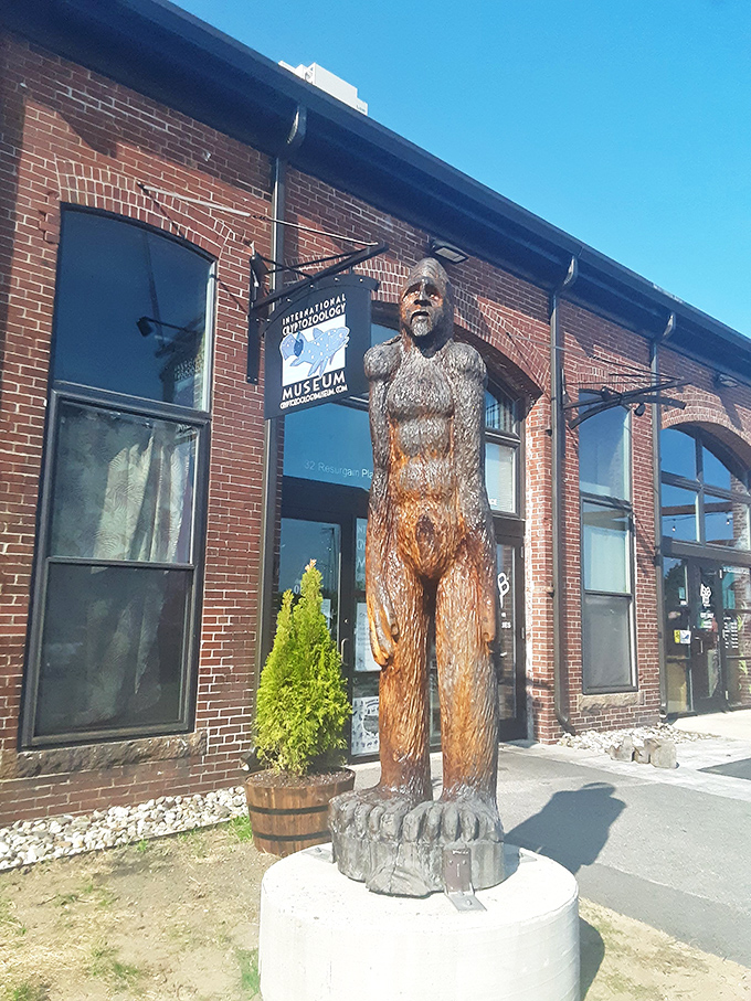 The guardian of cryptid secrets stands tall outside the museum, welcoming believers and skeptics alike with stoic wooden dignity.