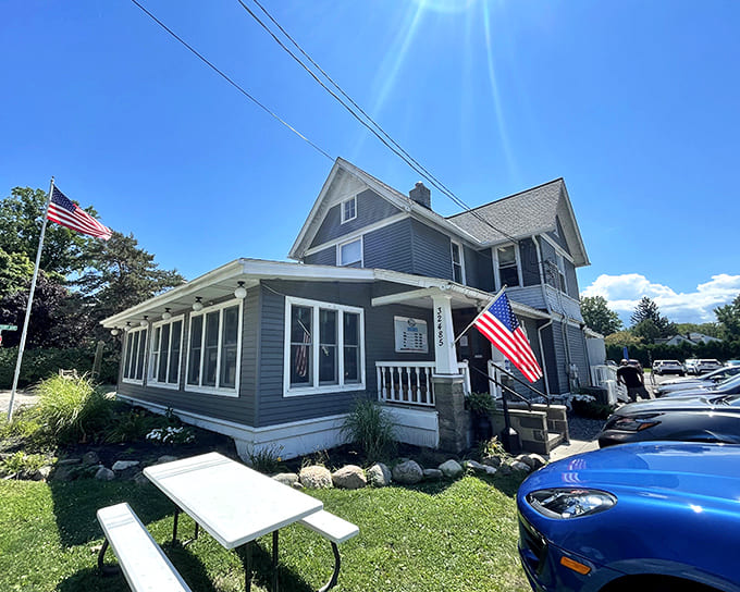 A charming blue clapboard house with American flags waving welcome &ndash; where Lake Erie's finest perch finds its perfect home.