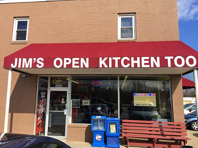 The unassuming exterior of Jim's Open Kitchen Too belies the culinary treasures within - that bright red awning is your beacon to breakfast bliss.