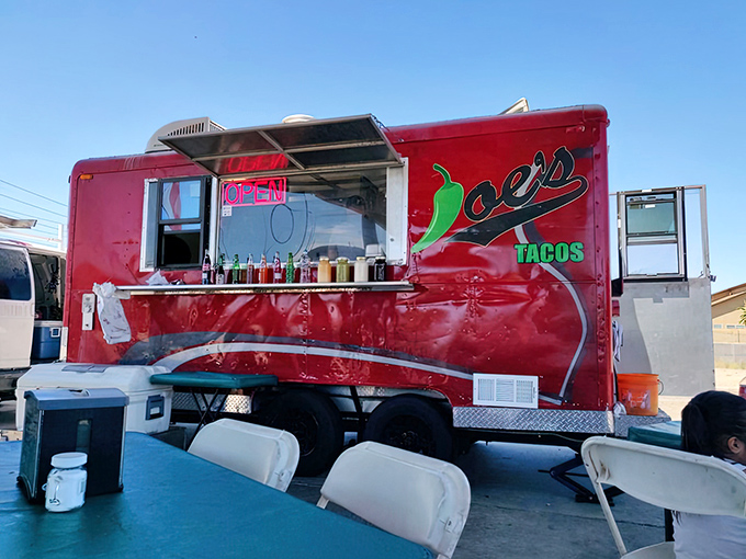 Joe's Tacos: A fiery red food truck that stands out like a culinary lighthouse in Peoria, beckoning hungry travelers with its vibrant chili pepper logo.