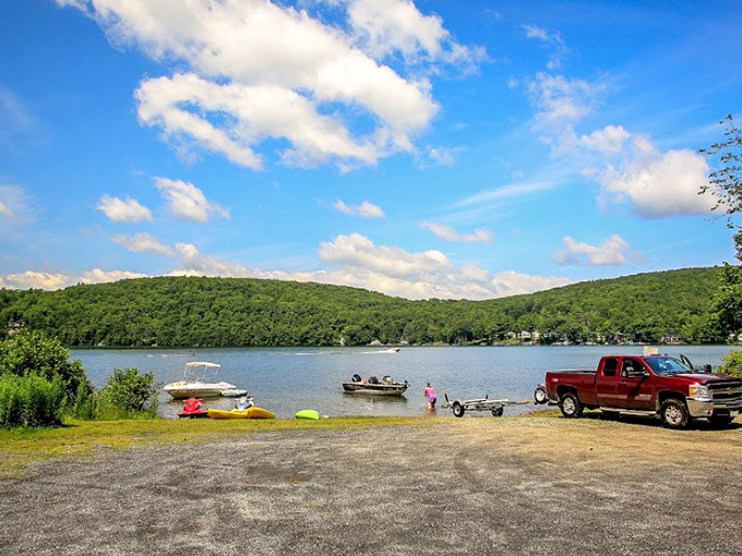 Lake St. Catherine's shimmering waters reflect Vermont's green mountains like nature's own infinity pool. Boats dot the surface while families create memories that'll last longer than their sunburns.