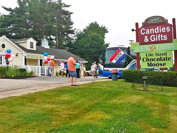 The welcoming facade of Len Libby Candies, where that iconic sign promises sweet adventures and a life-sized chocolate moose awaits inside.