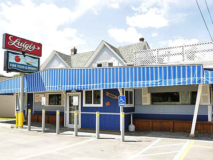Luigi's exterior welcomes hungry visitors with its distinctive blue facade and iconic red sign &ndash; a beacon of authentic Italian cuisine in Harrison Township.