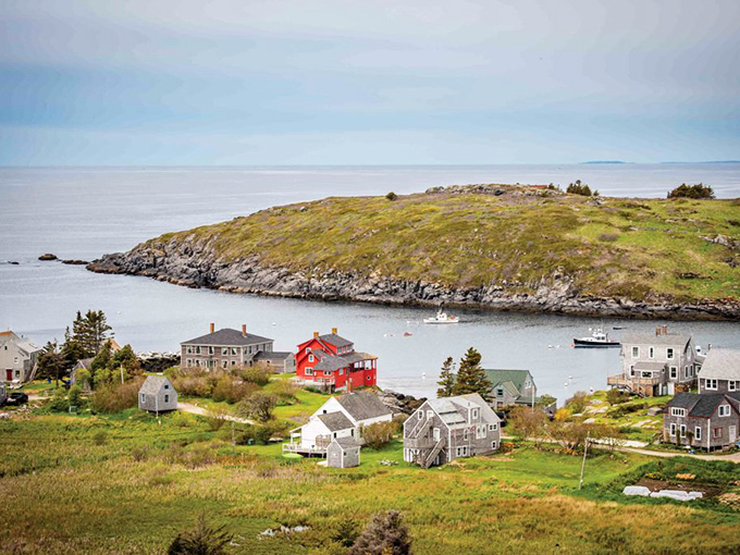 Monhegan Island emerges from the Atlantic like a painting come to life, its weathered cottages nestled against emerald hills and rugged shorelines.
