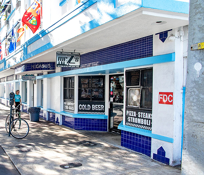 A blue-tiled beacon of culinary delight in Key West, where pizza dreams and cheesesteak fantasies come true daily.