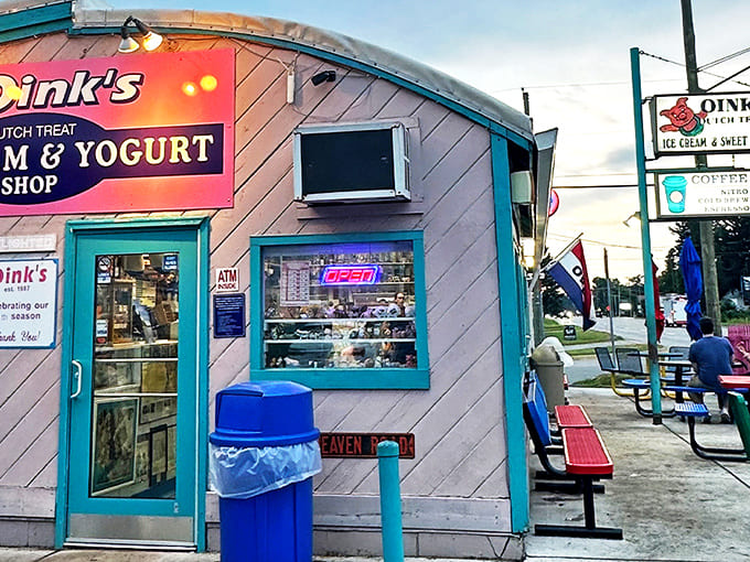 The pink-sided building with turquoise trim stands like a sweet mirage on the roadside, promising frozen delights within its whimsical walls.