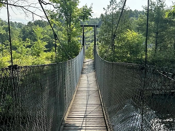 A suspended adventure awaits! This swaying footbridge over Otter Creek invites brave souls to cross into Vermont's natural wonderland.