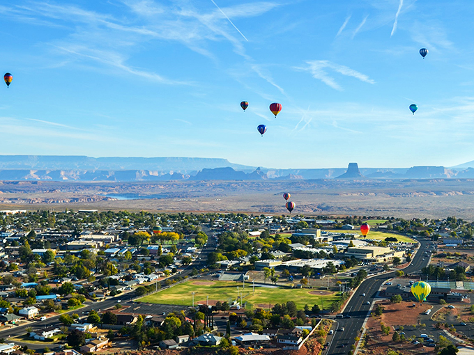 Hot air balloons dance across the desert sky as Page unfolds below, a perfect postcard moment of small-town charm meets epic landscape.