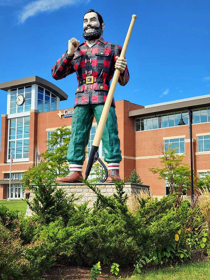 Paul Bunyan stands tall against the blue Maine sky, his 31-foot frame dwarfing the Cross Center behind him like a lumberjack among saplings.