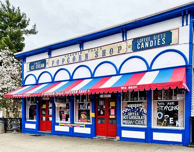 The iconic blue and white fa&ccedil;ade of Chagrin Falls Popcorn Shop beckons with its cheerful striped awning &ndash; a portal to snack paradise since 1949.