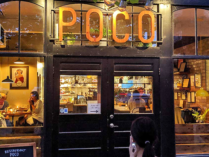 Restaurant Poco's warm glow beckons from North Winooski Avenue, its illuminated sign promising culinary treasures within this Burlington hideaway.