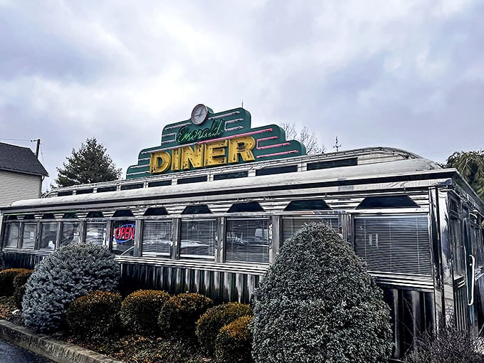 The gleaming stainless steel exterior of Rhonda's Emerald Diner catches the eye like a time machine disguised as a roadside attraction.