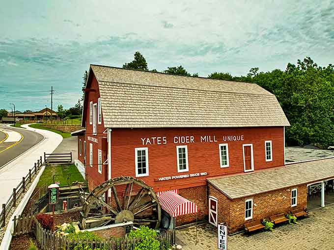 Exterior: The iconic red barn of Yates Cider Mill stands proudly against Michigan skies, its water wheel turning with the same purpose it has since 1863.
