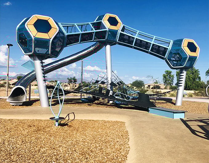 Signal Butte Park's entrance sign welcomes visitors with desert-inspired gabion walls and modern styling &ndash; Arizona's playground revolution starts here.