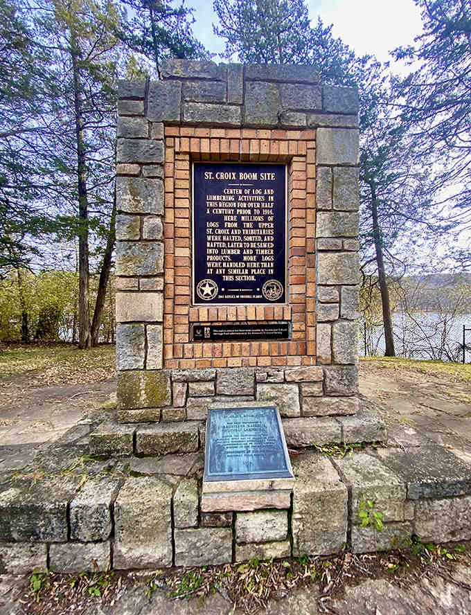 Historic monument stands sentinel at the St. Croix Boom Site, where timber tales and river history merge in stone-carved memories.