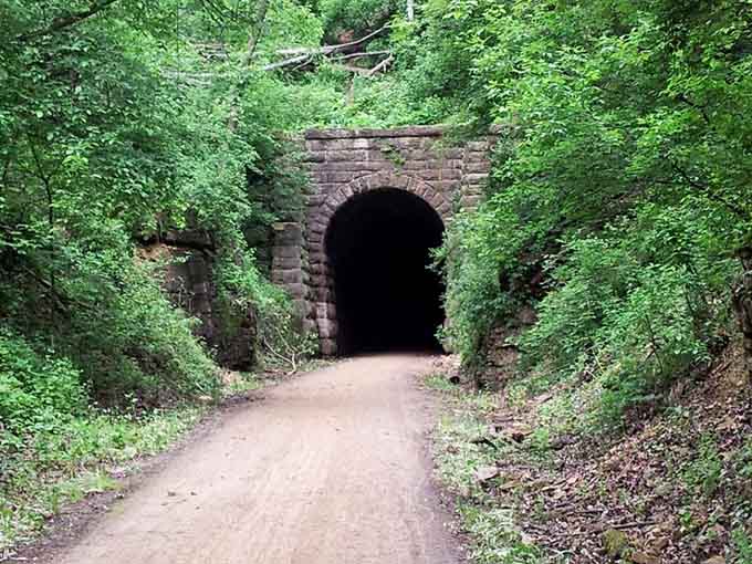 Nature's grand entrance: Towering limestone walls frame the Stewart Tunnel portal, where history and adventure beckon explorers of all ages.
