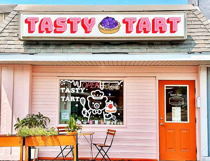 The charming pink exterior of Tasty Tart beckons with its playful signage and cartoon bear window art &ndash; a sweet beacon in Champaign's landscape.