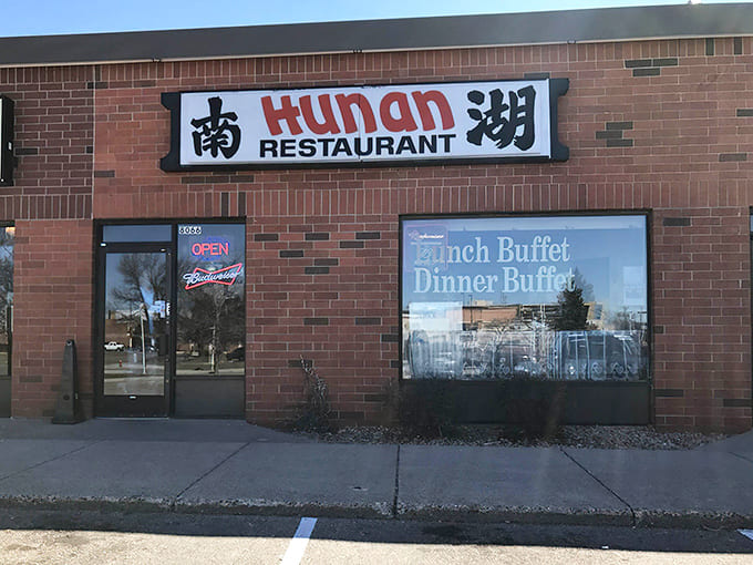 The unassuming exterior of Hunan Restaurant proves that the best flavors often hide behind the most modest facades in suburban strip malls.