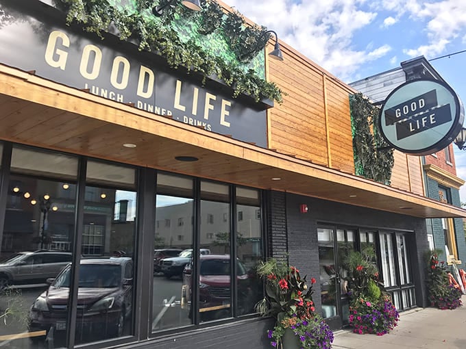 The Good Life Cafe's welcoming exterior promises good things inside, with flowers blooming like they know something you don't.