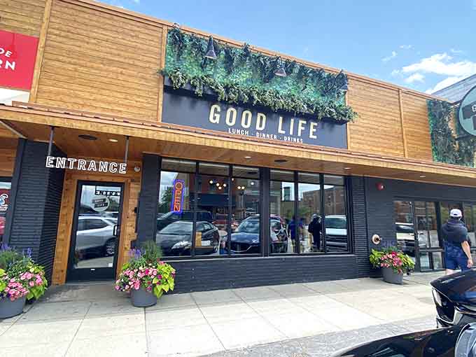 The Good Life Cafe's modern facade welcomes diners with natural wood tones and an inviting entrance that promises something special inside.