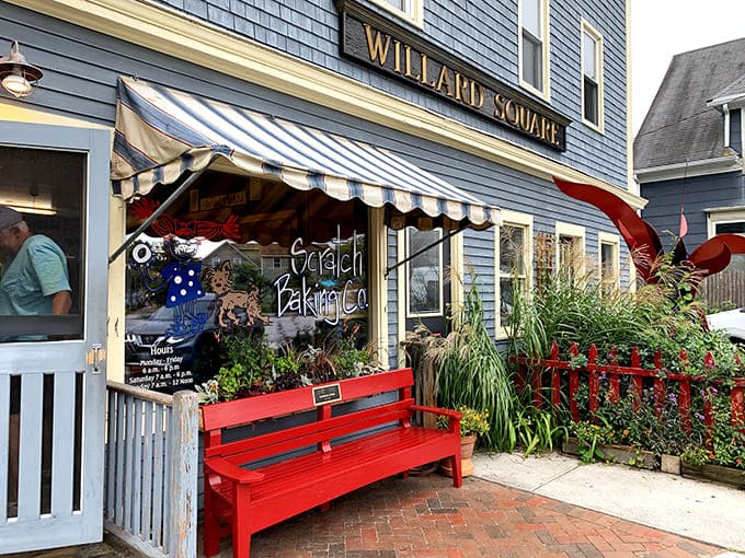 That charming blue exterior with the striped awning isn't just pretty; it's your first hint that something special awaits inside this South Portland gem.