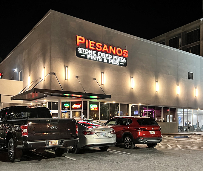 Piesanos' illuminated storefront beckons hungry patrons like a lighthouse for carb-seekers, promising stone-fired delights within its modern exterior.