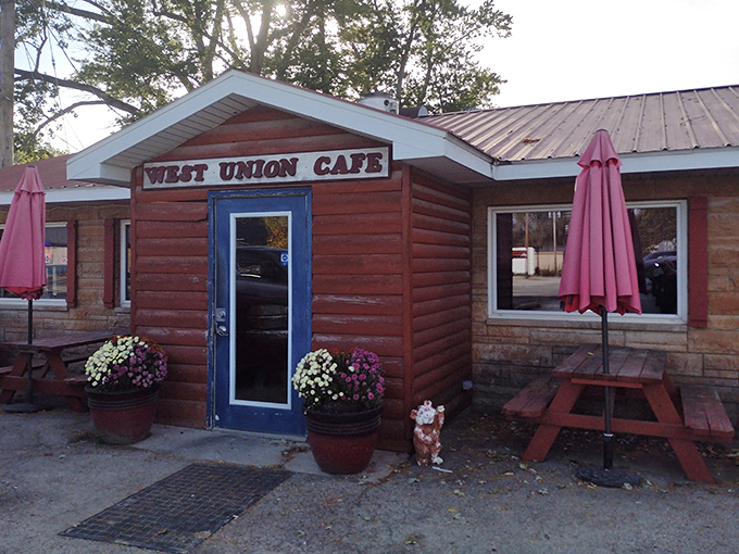 The rustic charm of West Union Cafe welcomes hungry travelers with its wooden exterior and iconic blue door.