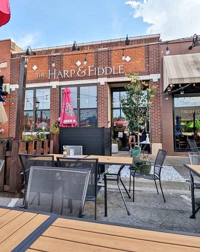 The brick facade of The Harp & Fiddle welcomes visitors with its classic pub charm and inviting outdoor seating area &ndash; a little slice of Ireland in Park Ridge.